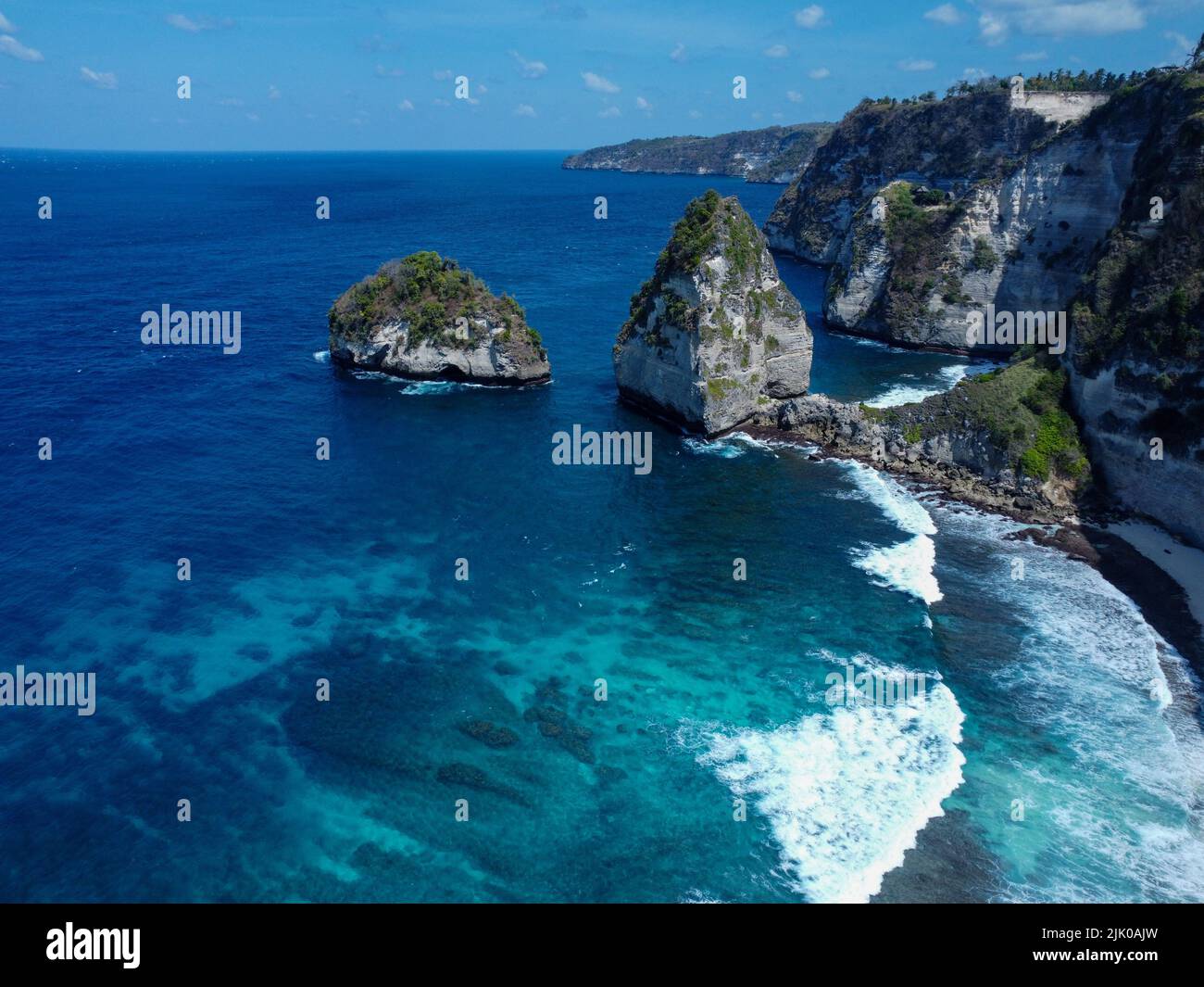 Aerial photo of Nusa Penida bay, white waves and crystal clear water ...