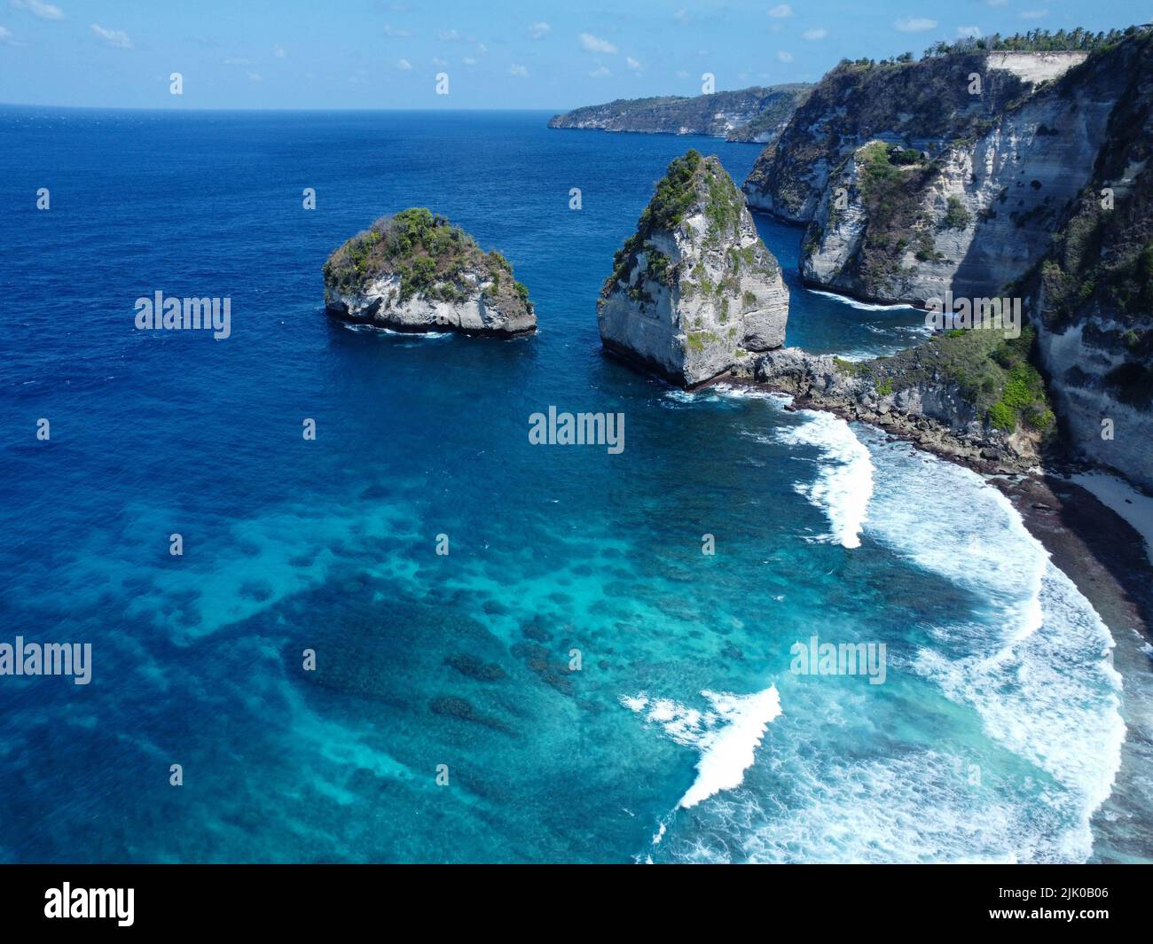 Aerial photo of Nusa Penida bay, white waves and crystal clear water ...