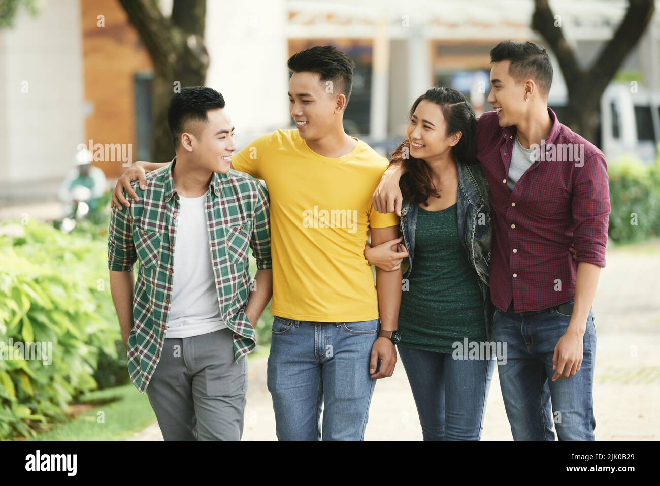 Happy Vietnamese friends walking outdoors Stock Photo - Alamy