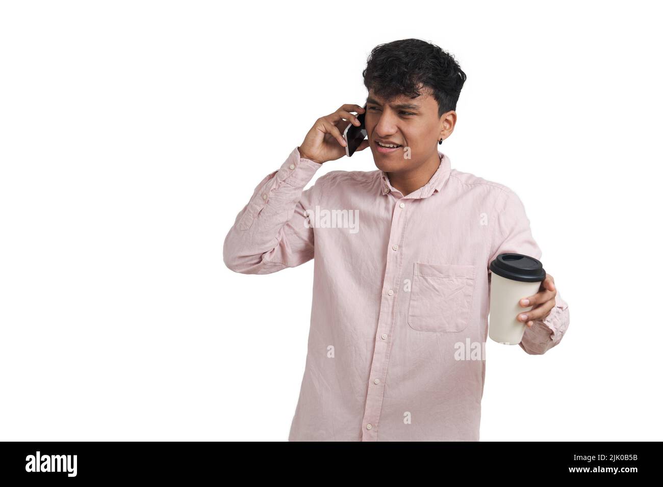 Young peruvian man angry speaking on the phone with a cup of coffee ...