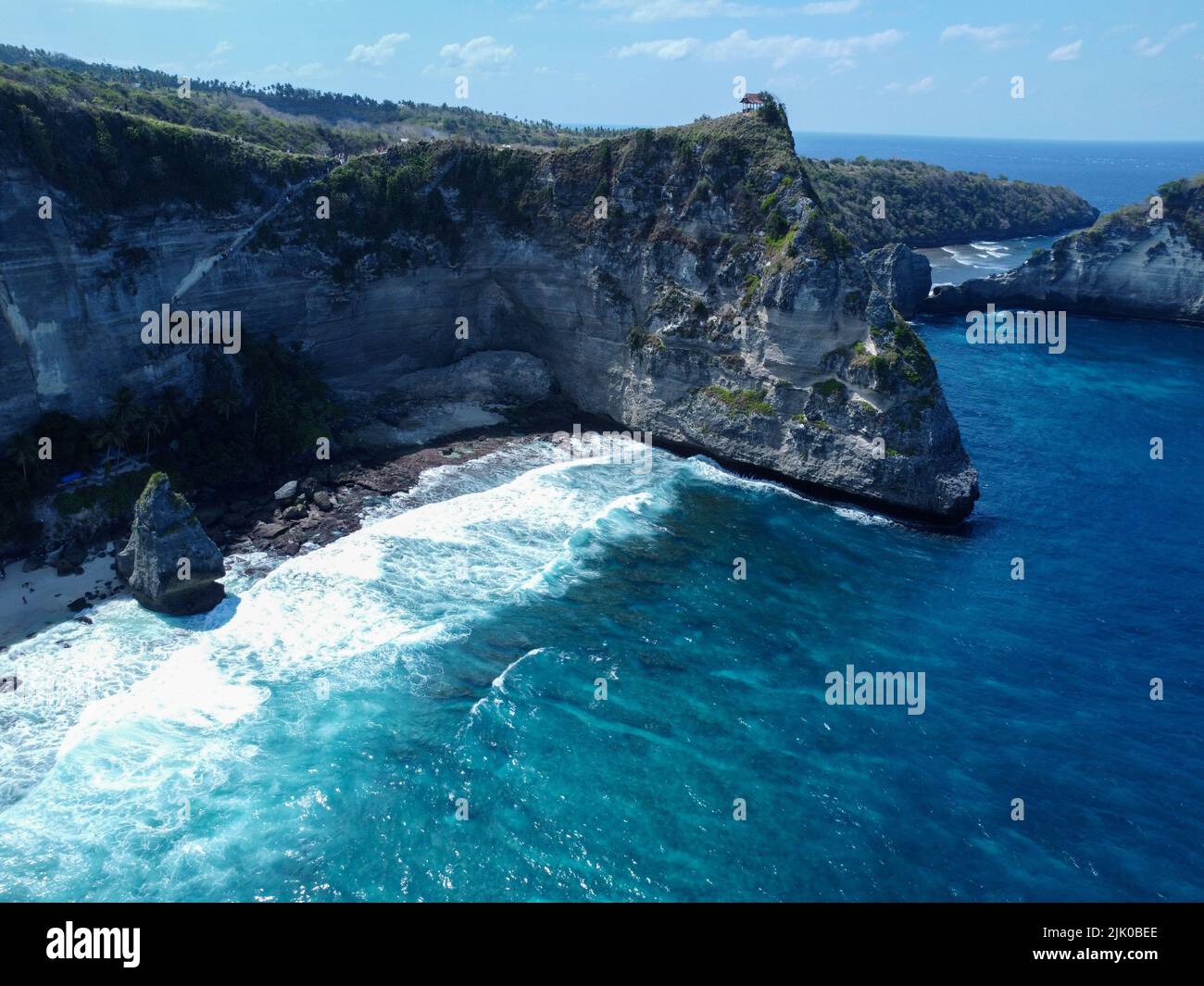 Aerial photo of Nusa Penida bay, white waves and crystal clear water ...