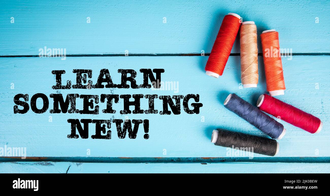 Learn something new. Text on blue wood texture background Stock Photo ...