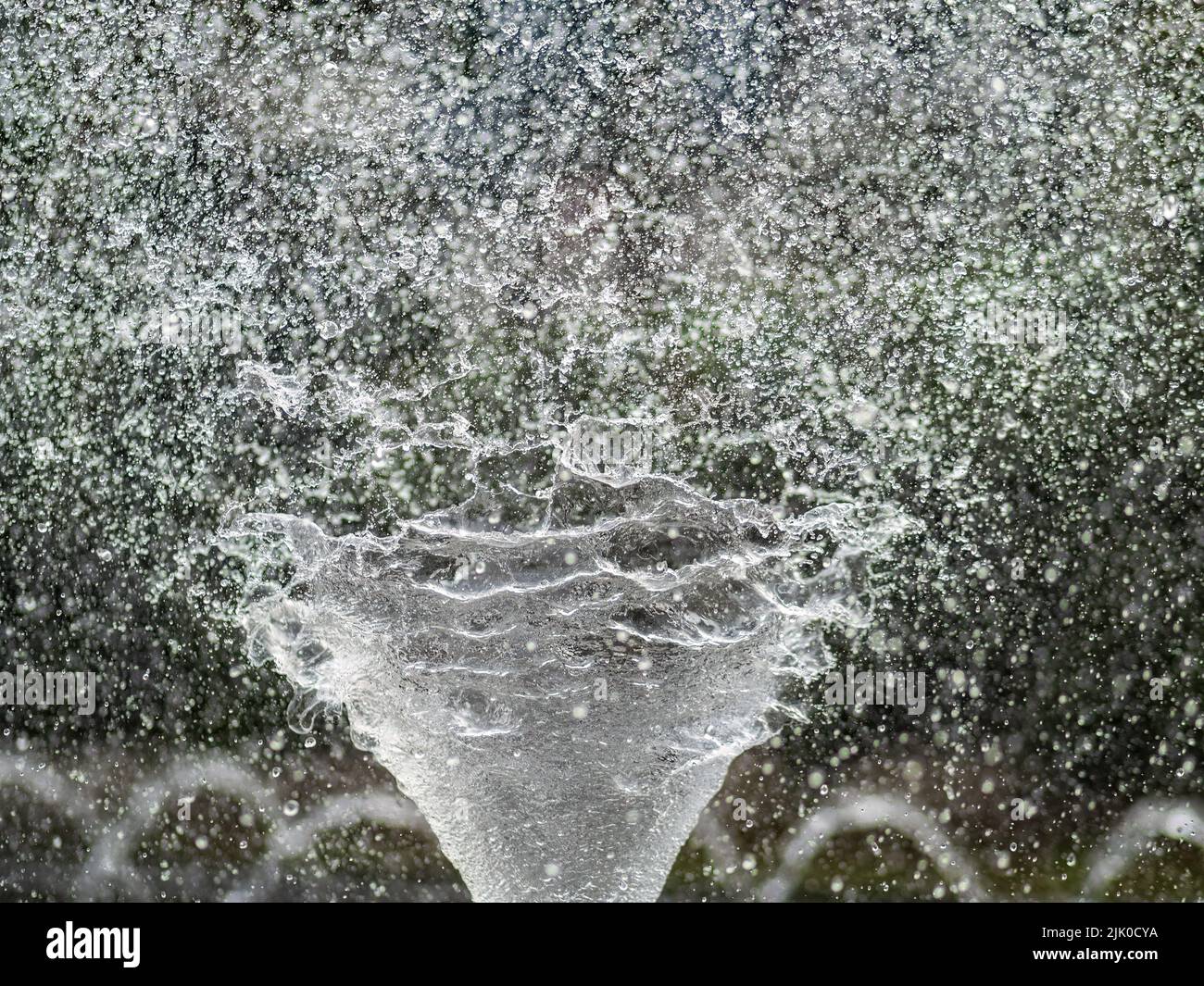 Water splashes from fountain on dark background. Natural texture of ...