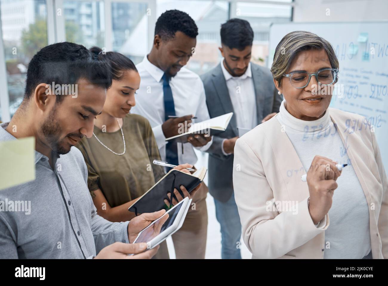 Guiding her team towards the best results. a mature businesswoman ...