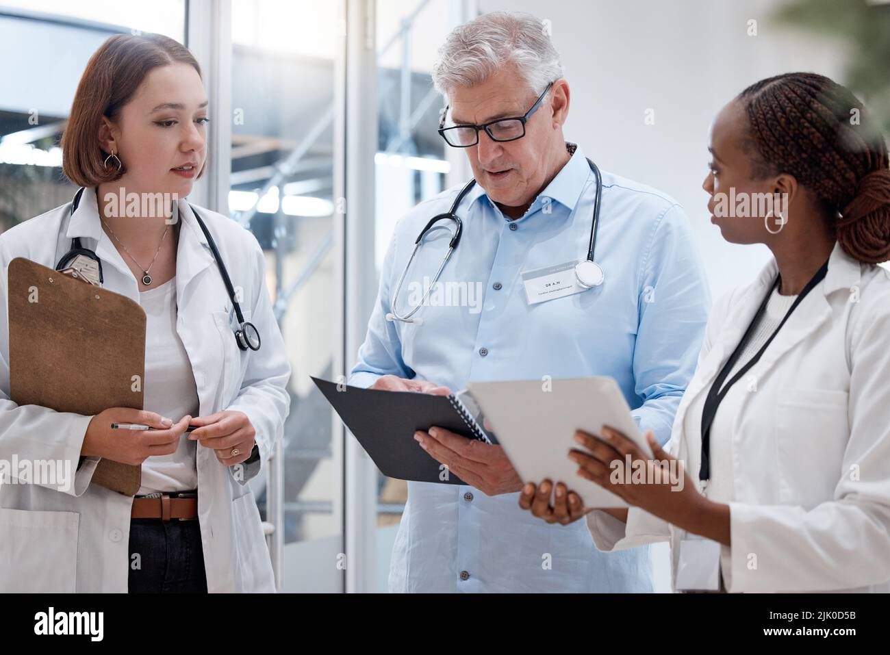 This chart looks worrying. a team of doctors reading through medical ...