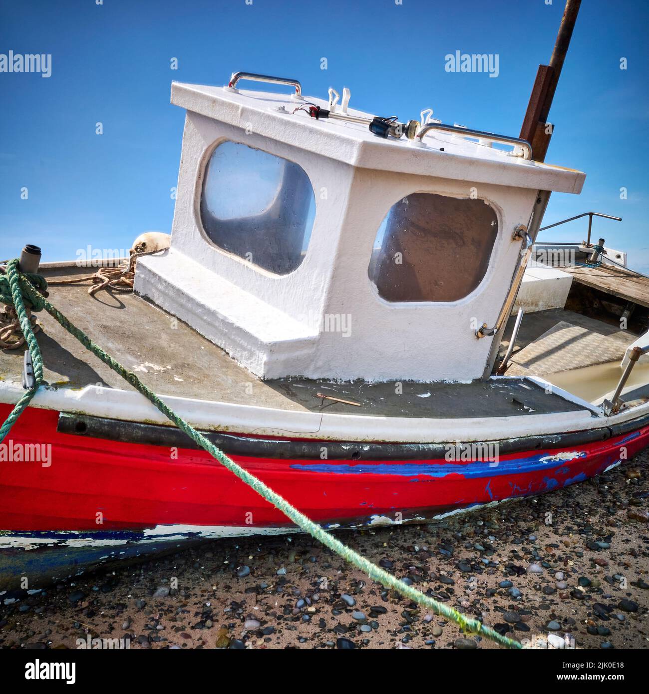 Old water logged fishing boat on beach at Fleetwood in summer Stock ...