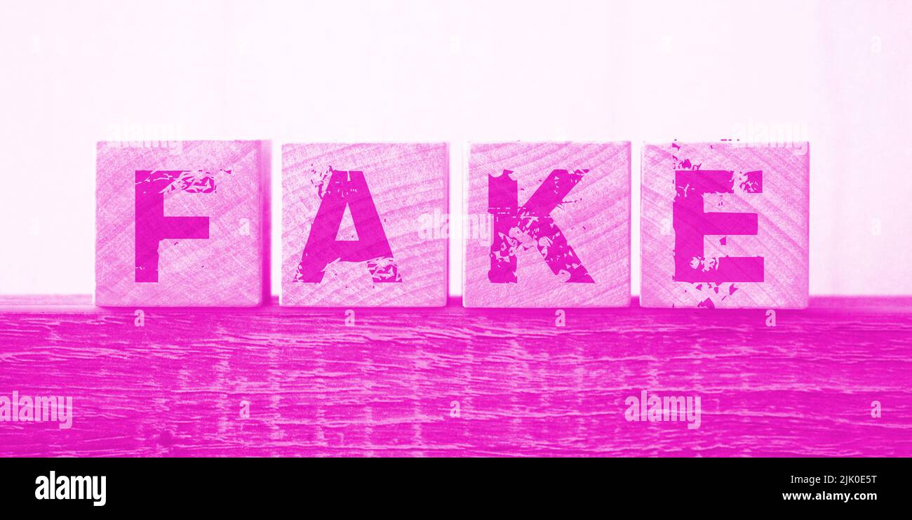 Fake word letters on wooden blocks, over dark oak table. True and lies ...