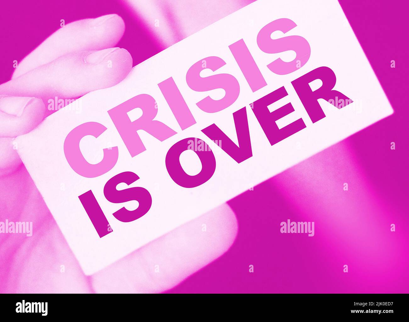 Crisis is over words on card Businessman is holding. Word Crisis, risk ...