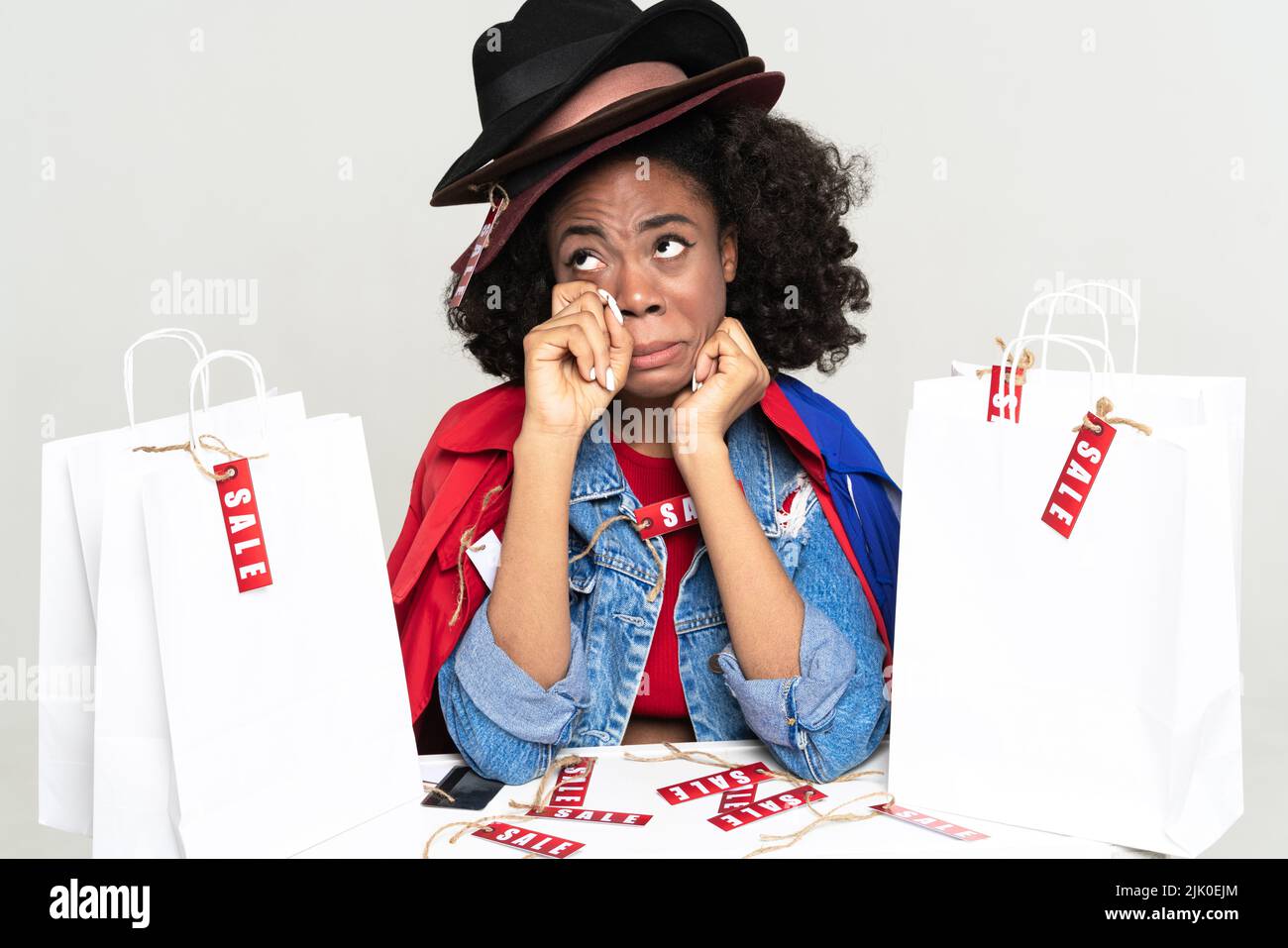 Black young woman crying while posing with shopping bags isolated over ...