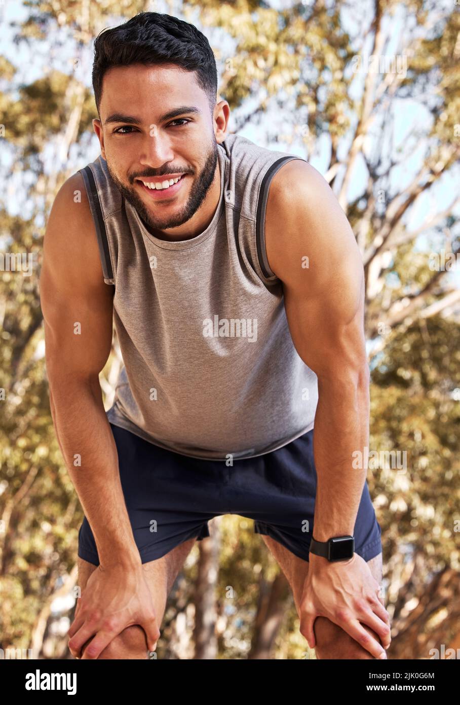 Smile and keep going. a handsome young man taking a moment to catch his ...