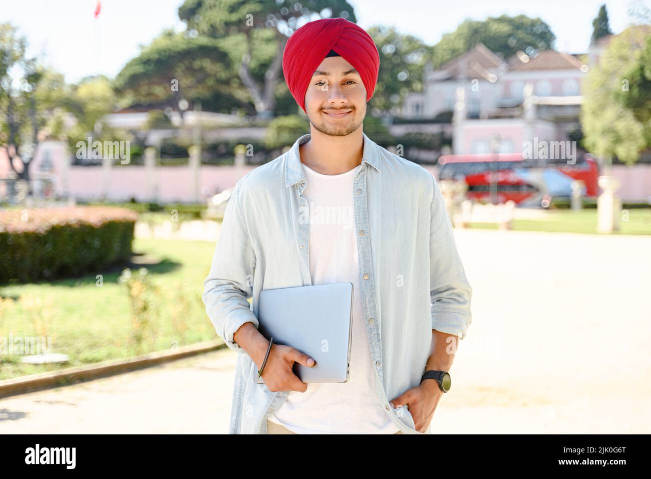 Working with joy. Smiling cheerful Indian freelancer man wearing ...