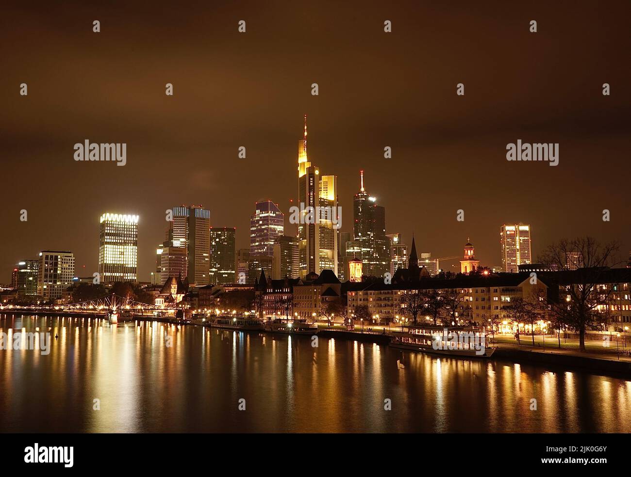 A beautiful urban view of illuminated buildings with water on the ...