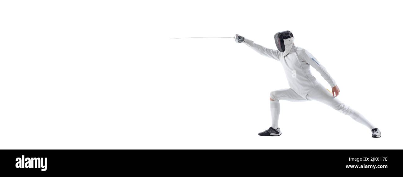 Dynamic portrait of young man, fencer in in fencing costume with sword ...