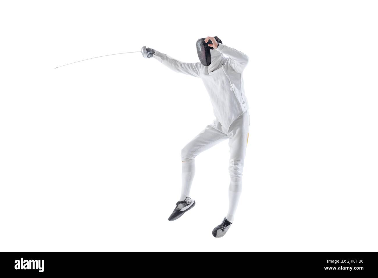 Dynamic portrait of young man, fencer in in fencing costume with sword ...