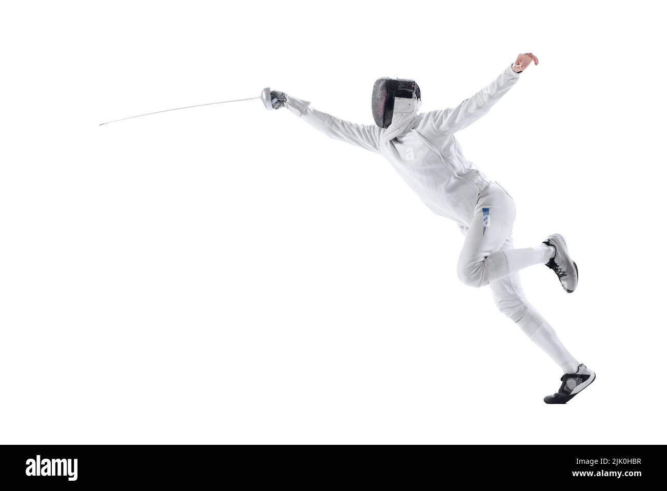 Dynamic portrait of young man, fencer in in fencing costume with sword ...