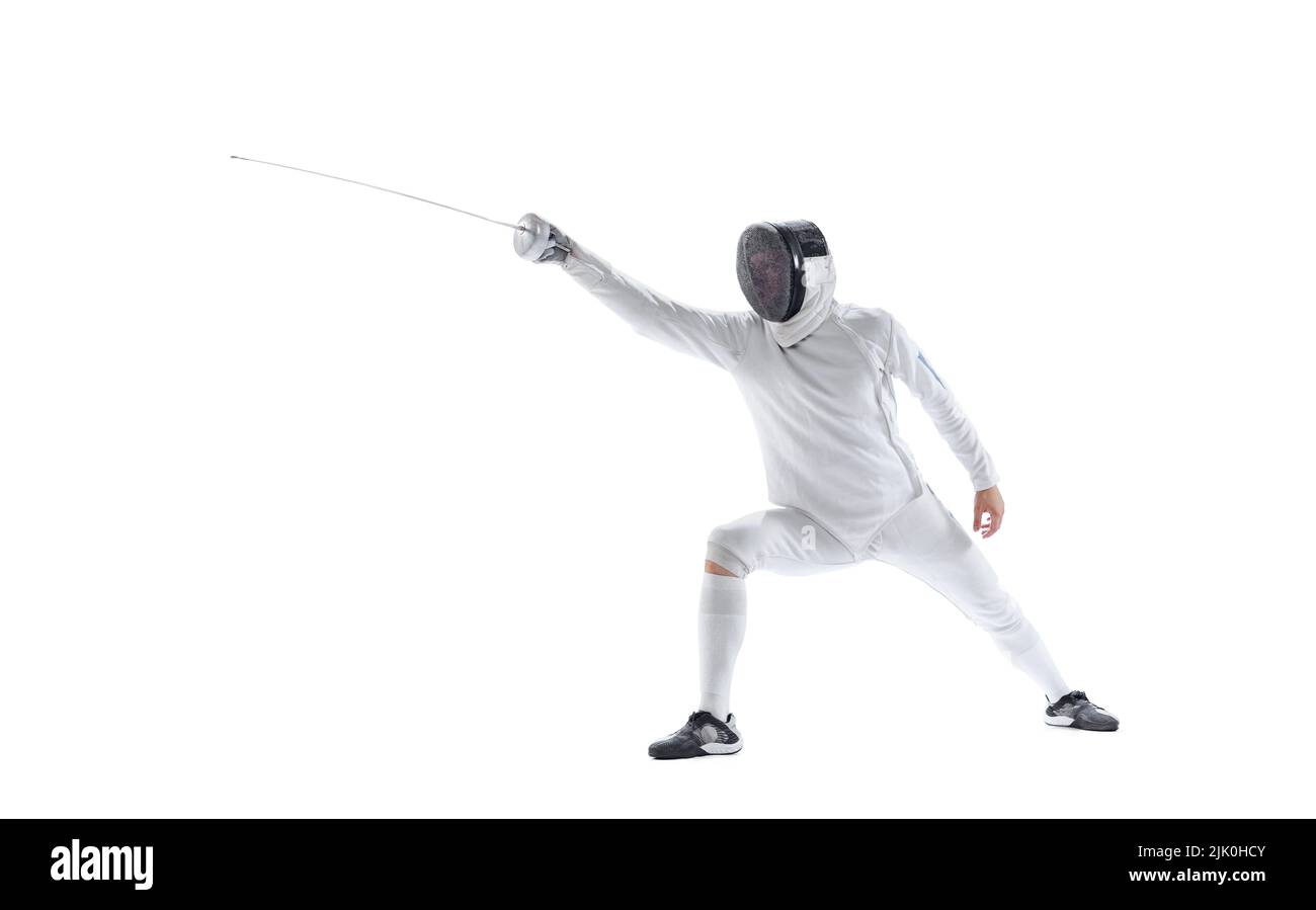 Dynamic portrait of young man, fencer in in fencing costume with sword ...