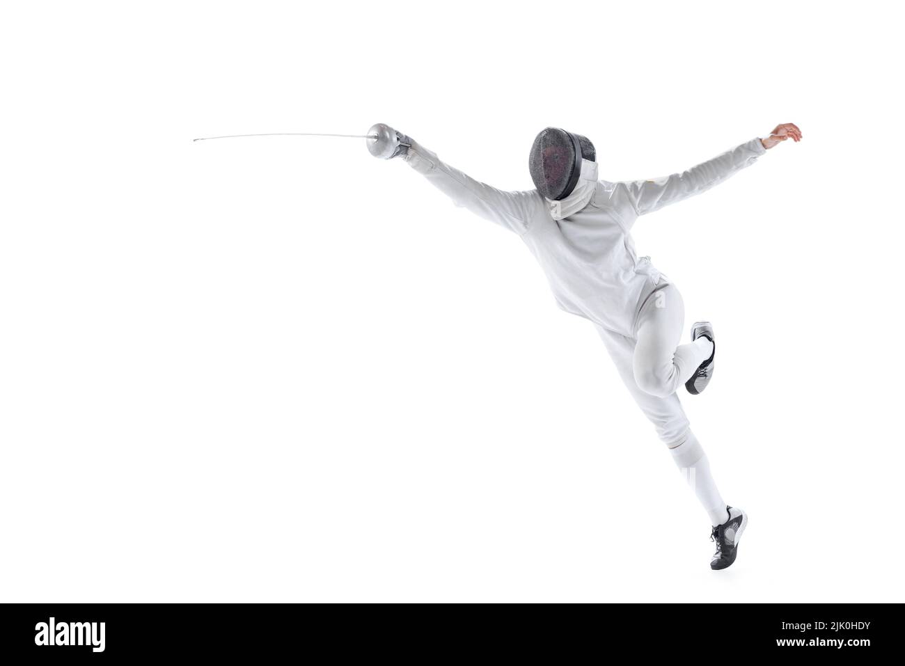 Dynamic portrait of young man, fencer in in fencing costume with sword ...