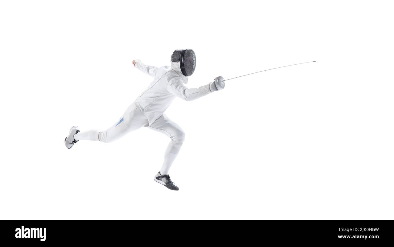 Dynamic portrait of young man, fencer in in fencing costume with sword ...