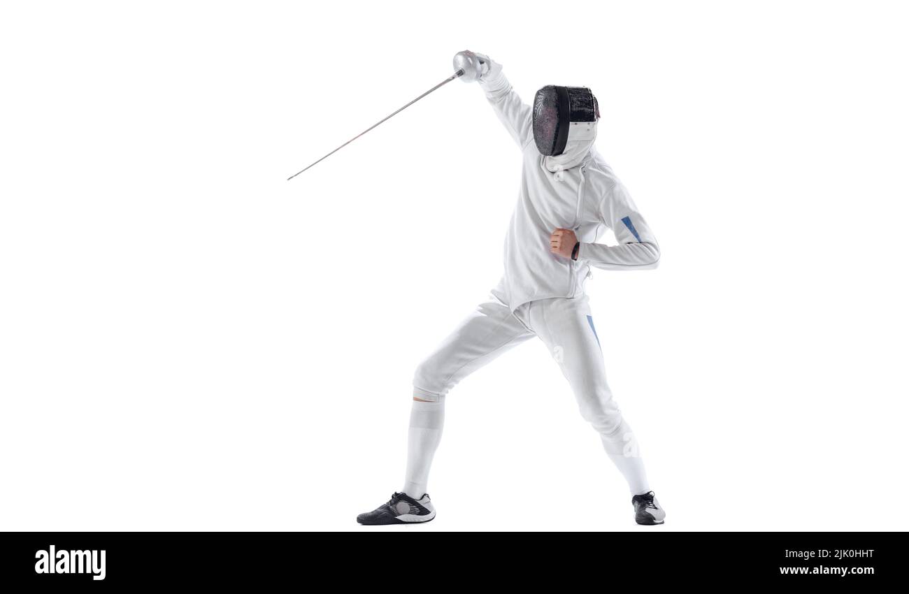 Dynamic portrait of young man, fencer in in fencing costume with sword ...