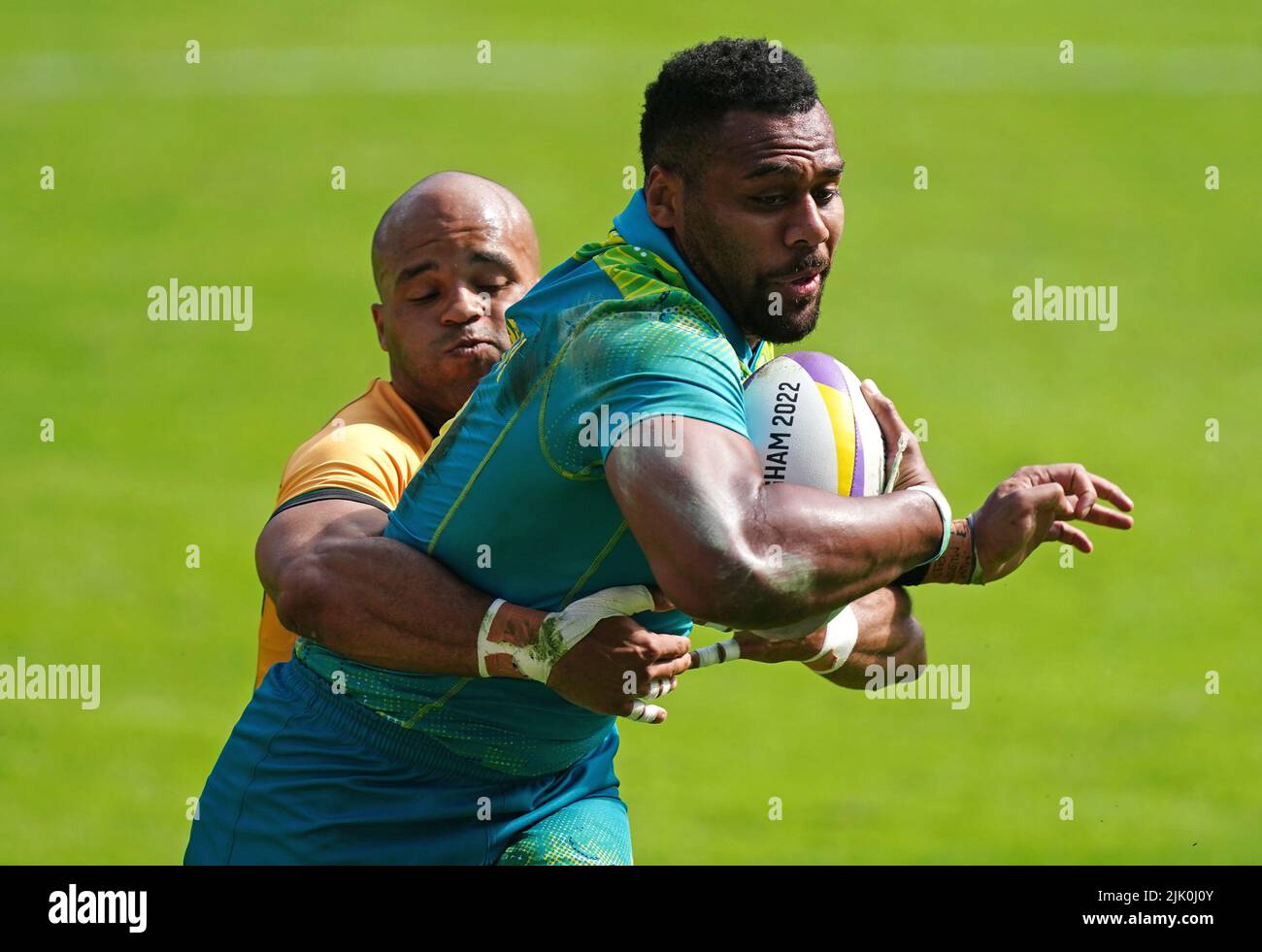 Australia's Samu Kerevi (right) is tackled by Jamaica's Dy'Neal Fessal ...