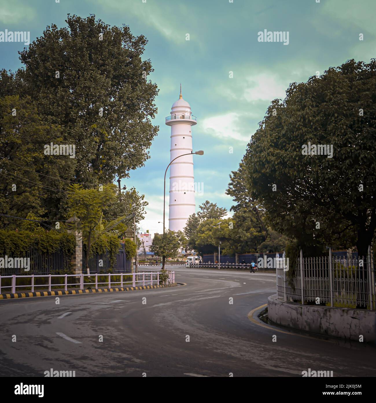 A beautiful shot of a street leading to Dharahara Tower at the centre ...