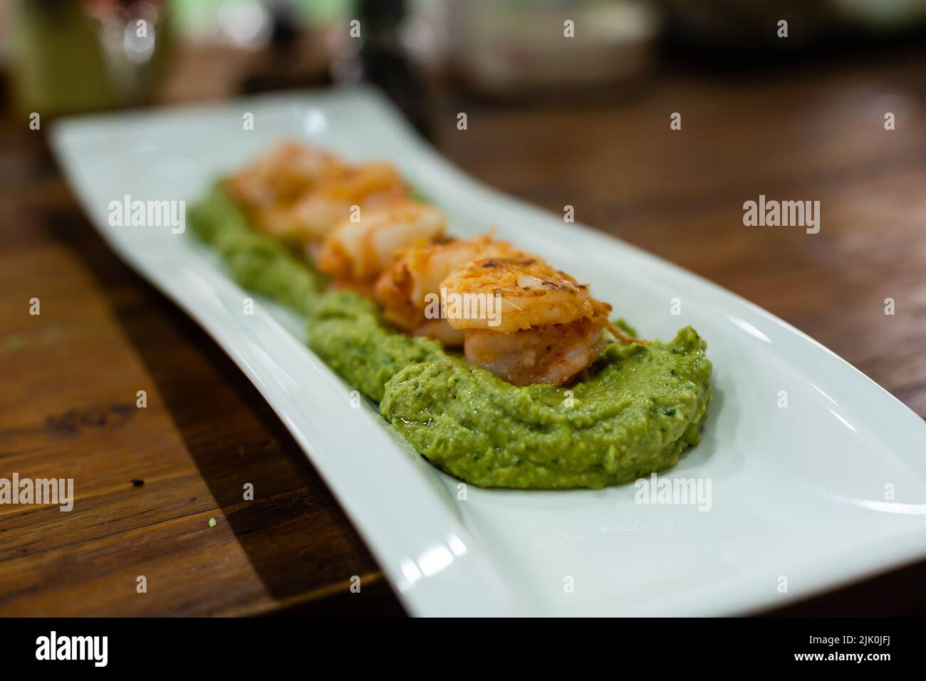 fried prawns on sweet potato puree Stock Photo - Alamy