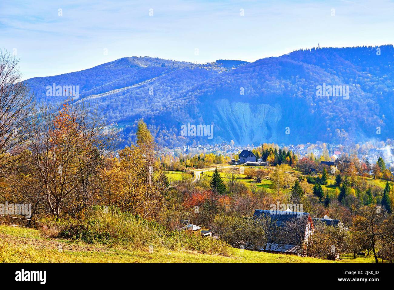 Aerial view of an autumn small village in a valley and mountains in a ...