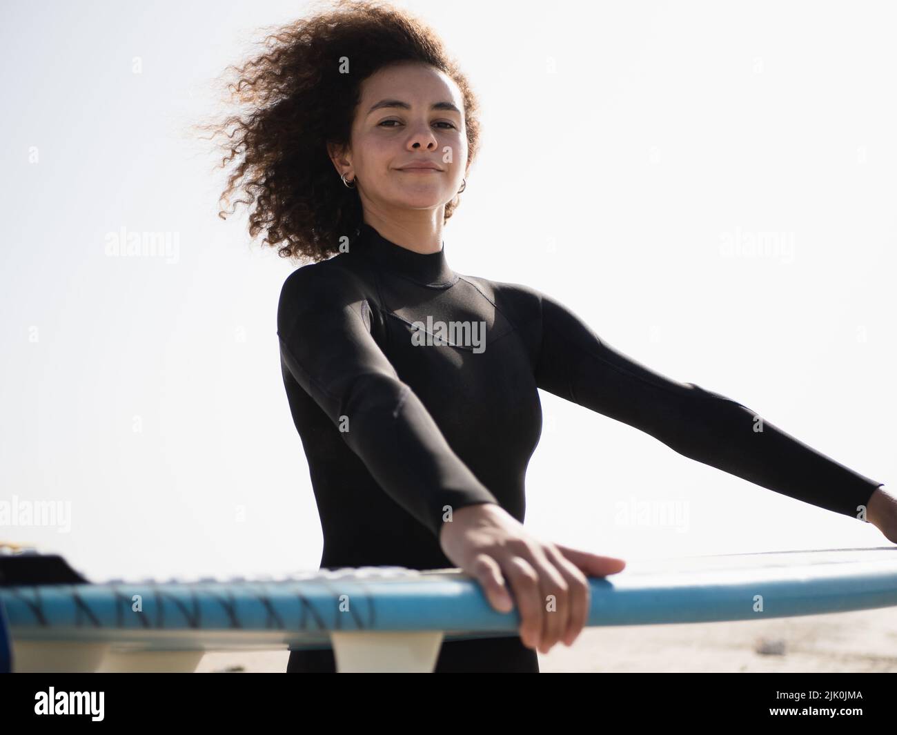 Young multiracial surfer female with afro hair portrait Stock Photo - Alamy