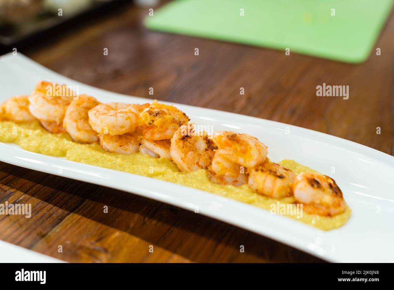 fried prawns on sweet potato puree Stock Photo - Alamy