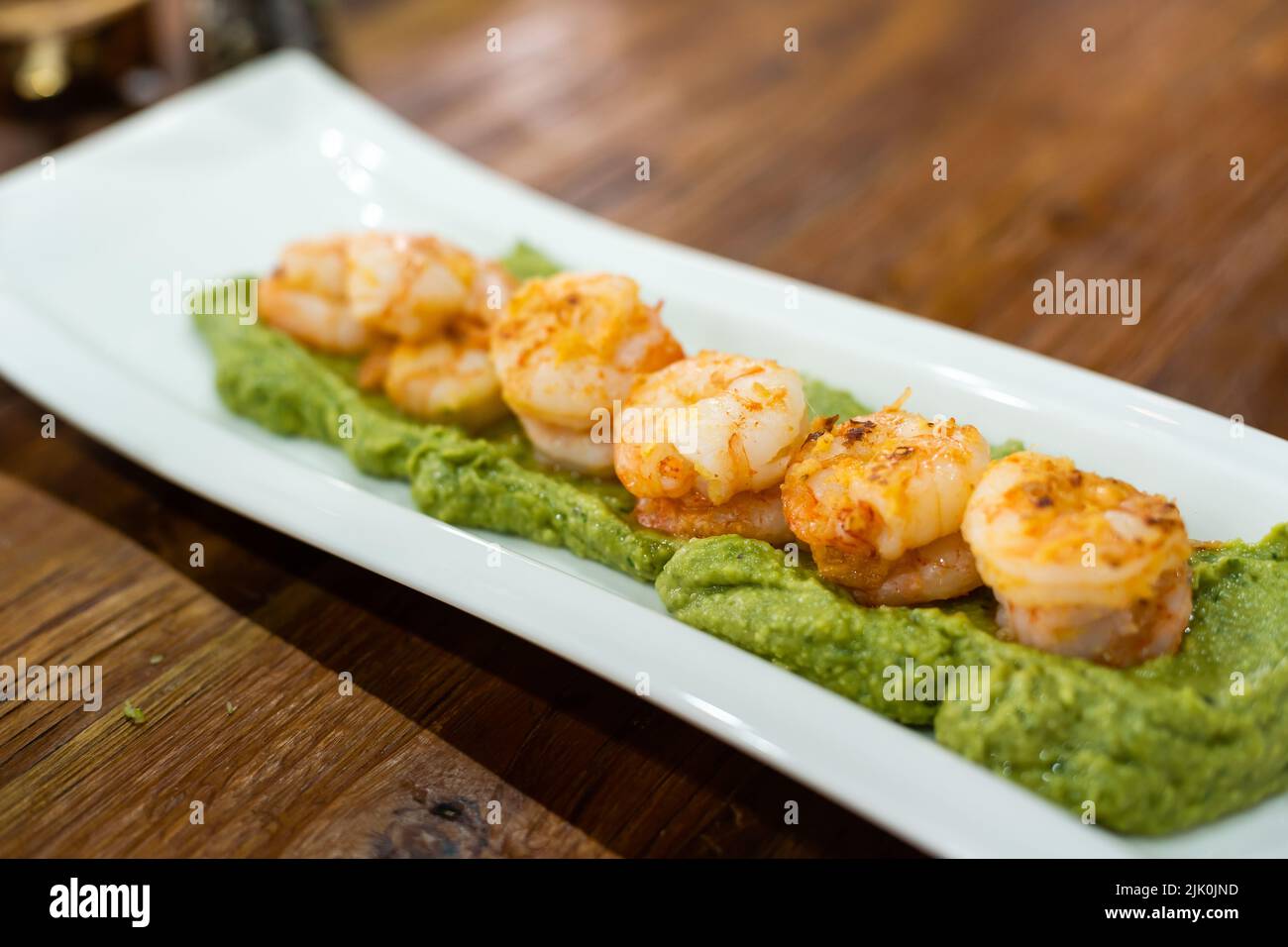 fried prawns on sweet potato puree Stock Photo - Alamy