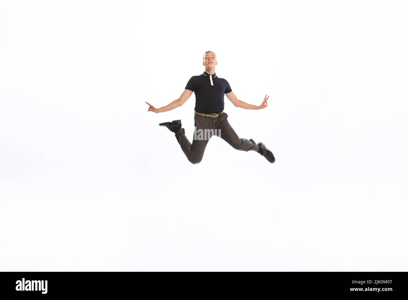 Portrait of young man in stylish black outfit posing isolated over ...