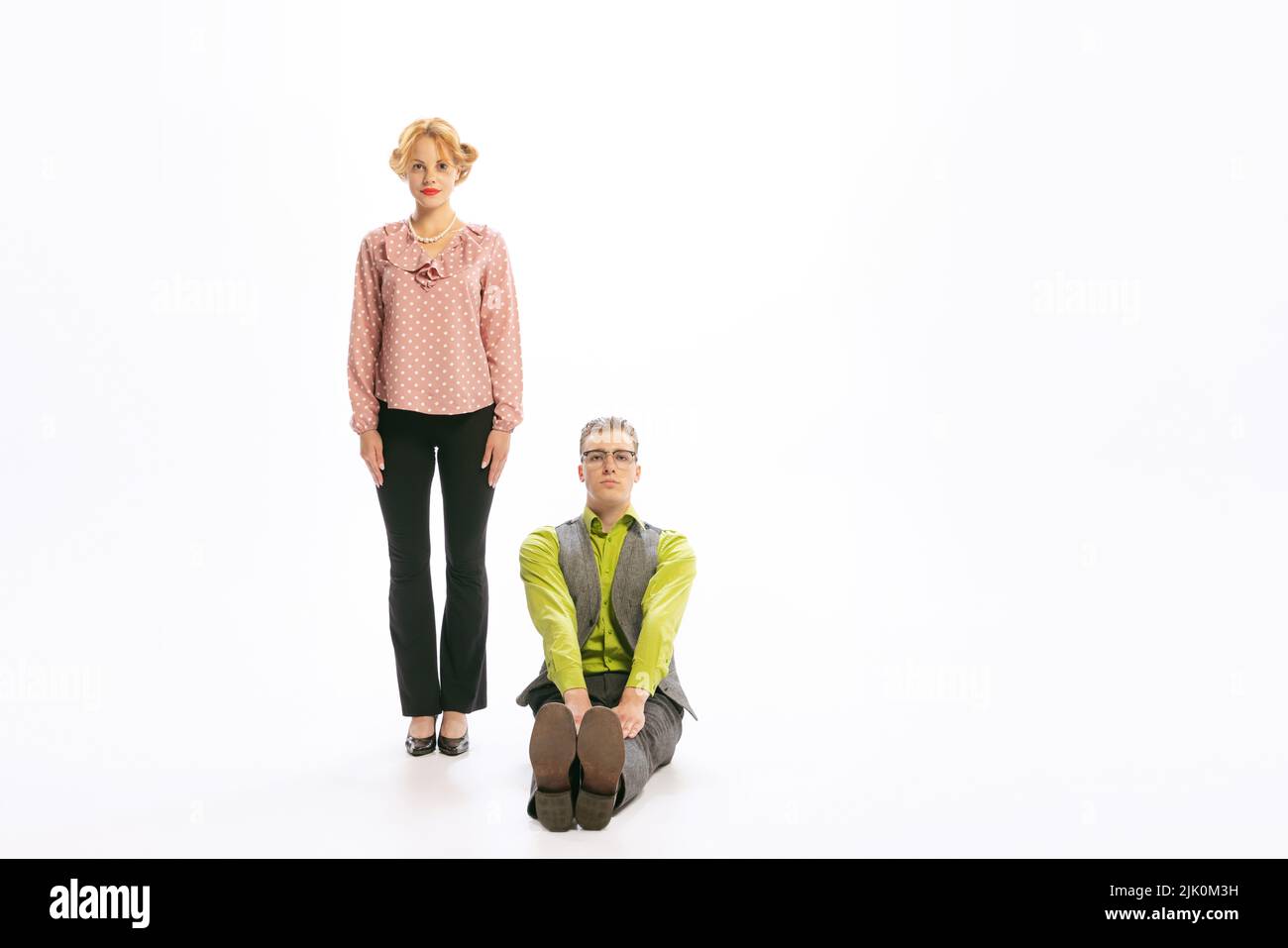 Portrait of young woman and man with emotionless facial expression ...