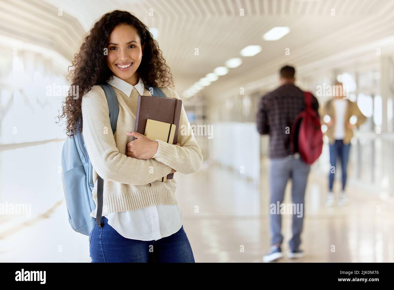 Im ready for class. Cropped portrait of an attractive young female college student standing with ...