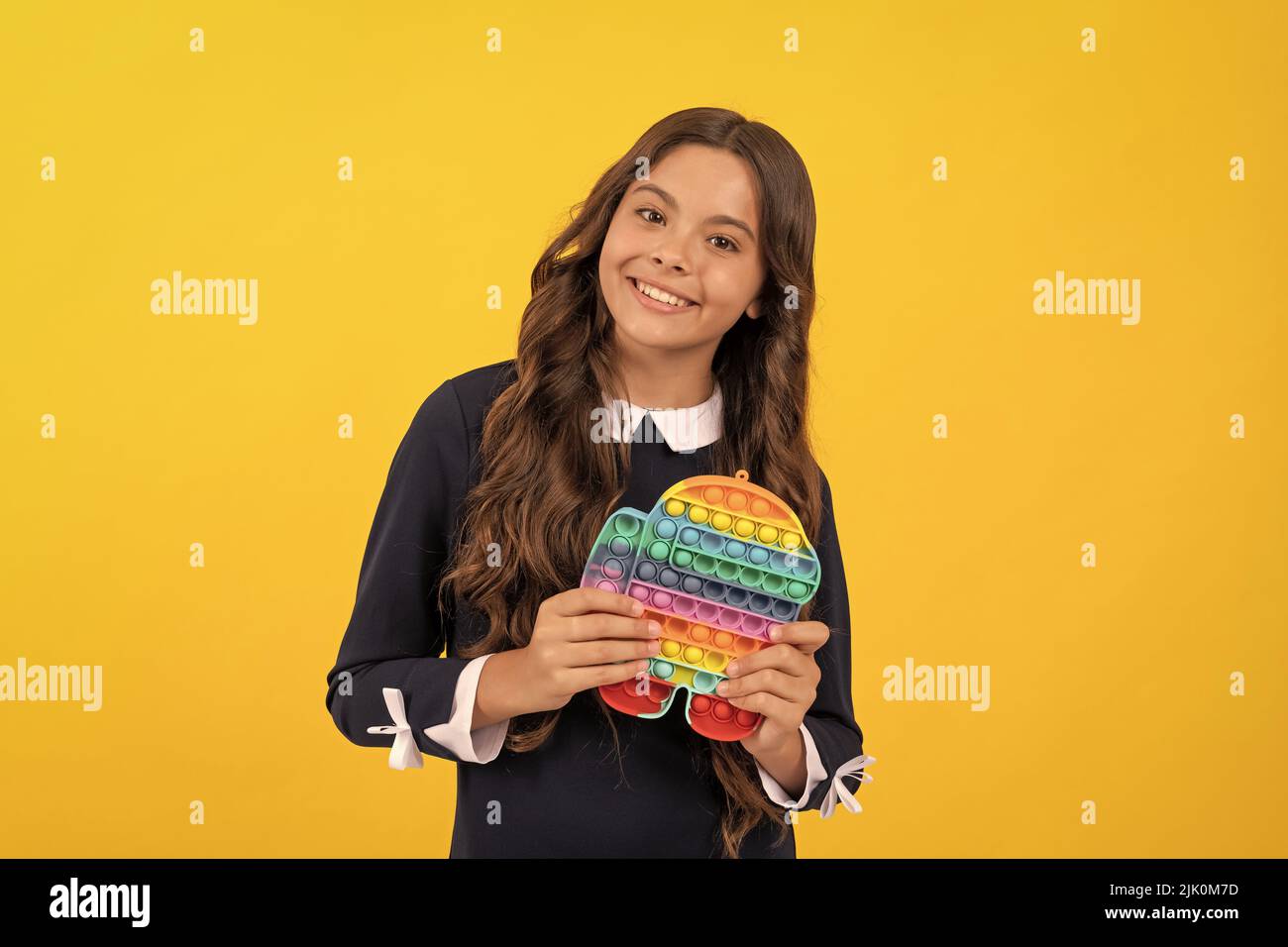 motor skills. pop it fun. cheerful child presenting color popit fidget ...