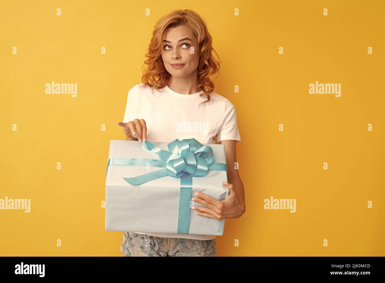 cheerful dreamy redhead lady opening giftbox. womens day Stock Photo ...