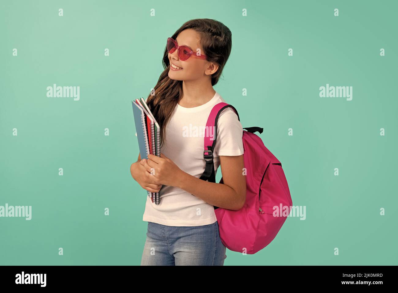 happy teen girl carry backpack and notebook. back to school. knowledge ...