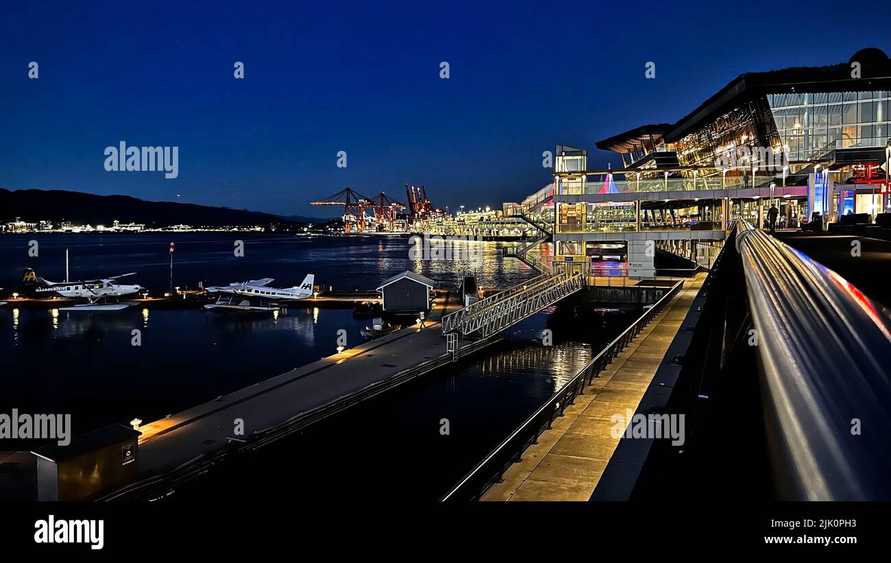 A beautiful view of Coal Harbor in Vancouver, Canada with glowing ...