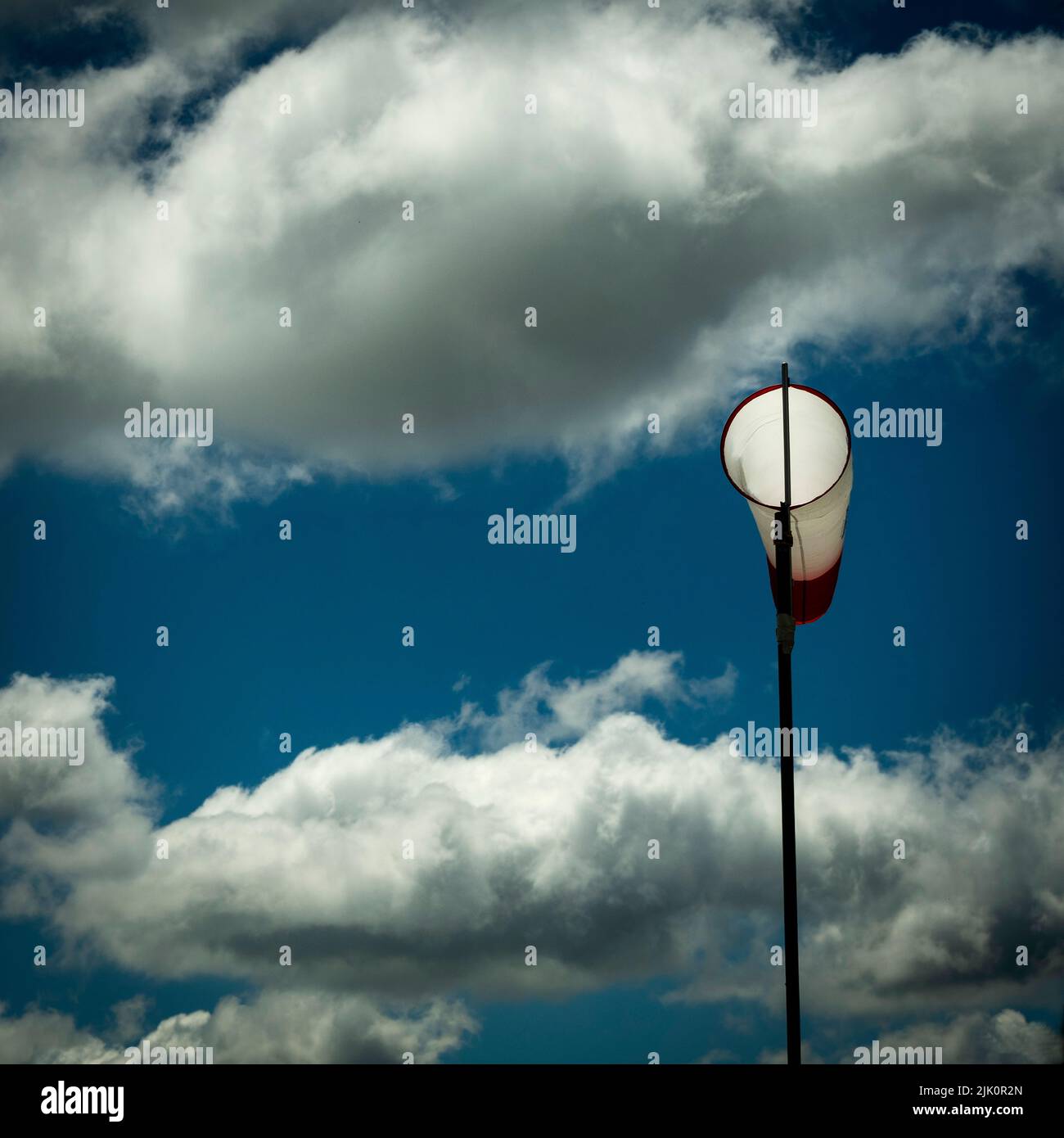 Windsock signaling wind direction under a blue sky with clouds Stock ...