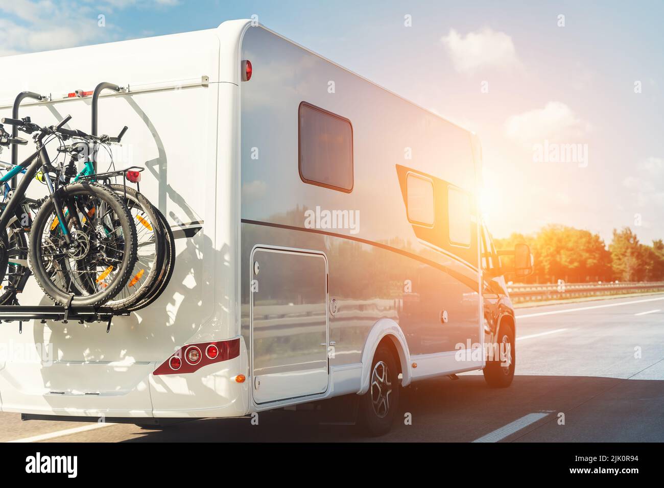 Scenic view big modern white family rv camper van vehicle driving on ...