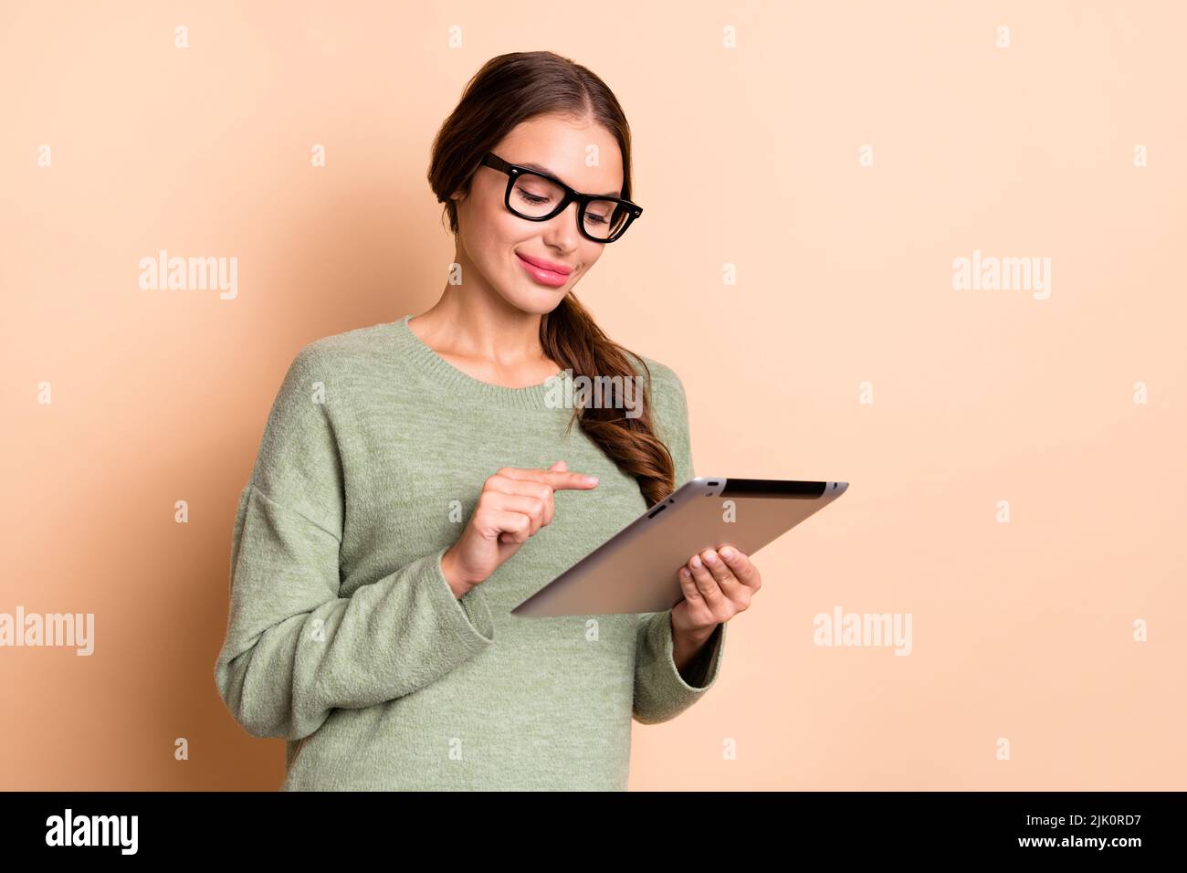 Photo of cute shiny girl dressed green pullover eyewear typing modern ...