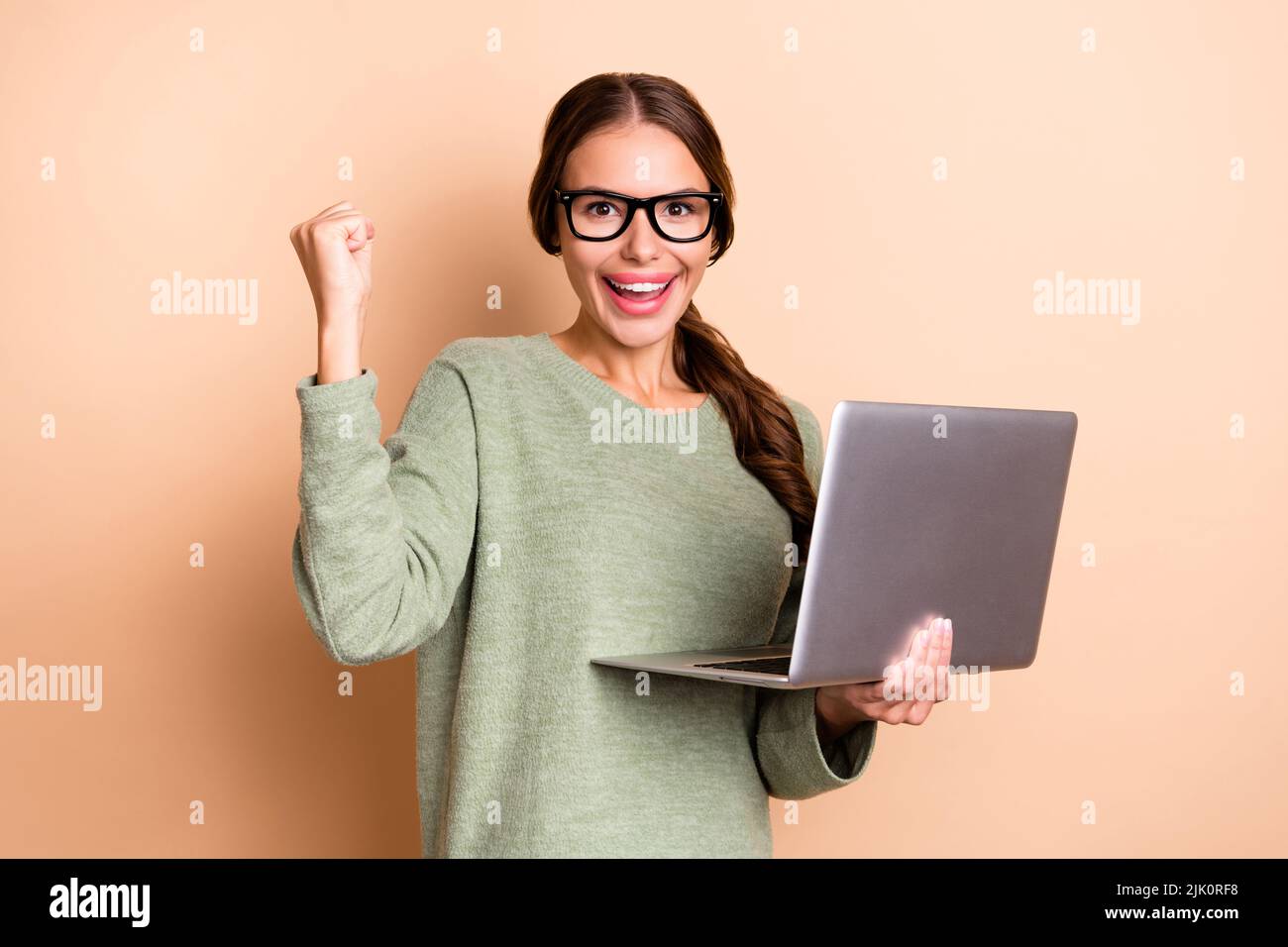 Photo of excited lucky lady wear green sweater spectacles rising fist ...