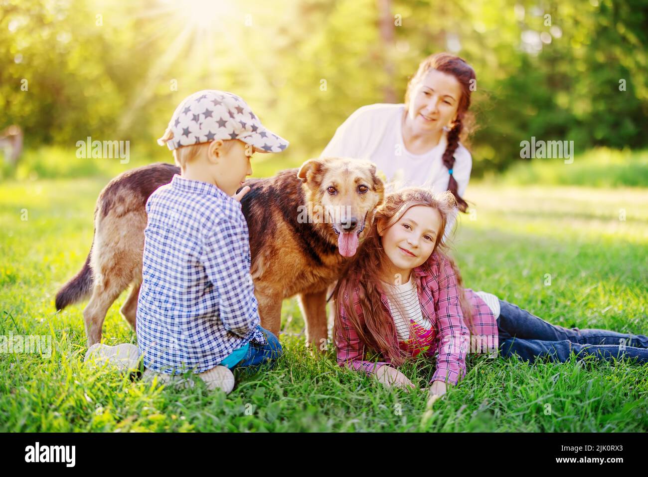 Children and mother with a dog in nature Stock Photo - Alamy
