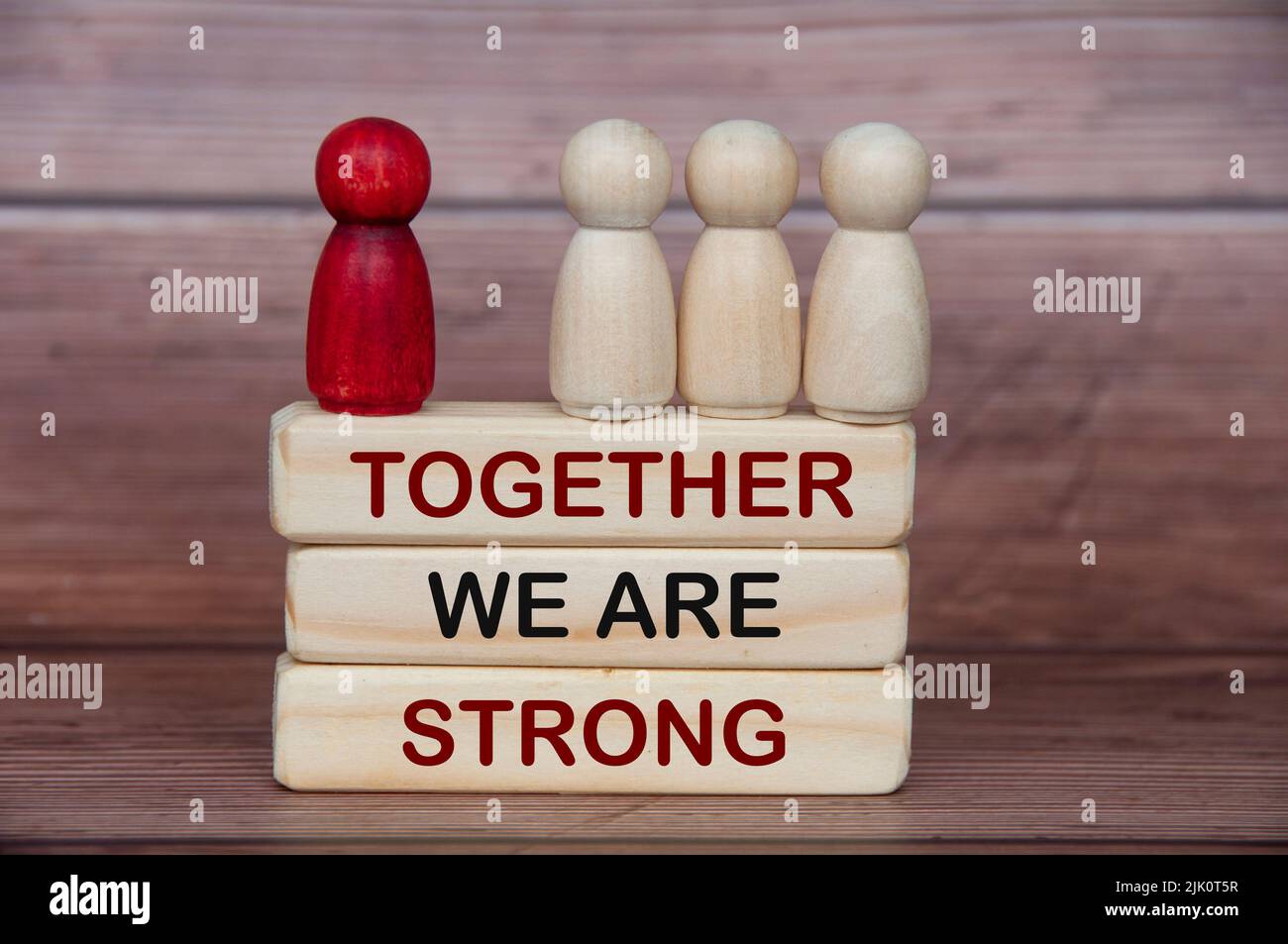 Leadership and teamwork concept - wooden figure dolls on top of wooden ...