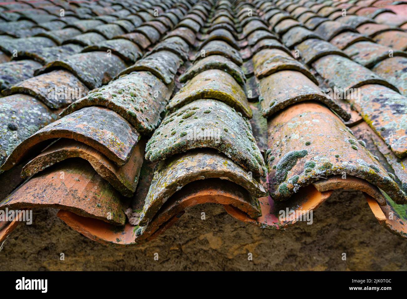 Old medieval house roof made with clay tiles aged by the passage of ...