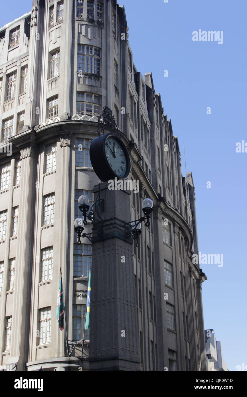 A City clock pole in a vertical shot Stock Photo - Alamy