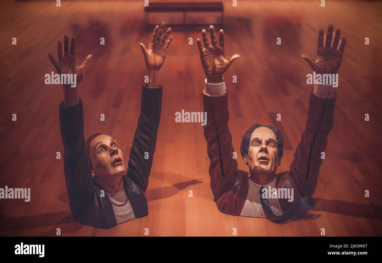 The high-angle view of statues of man and woman rising their hands ...