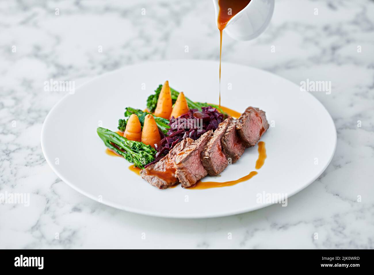 Roast beef with gravy being poured Stock Photo - Alamy