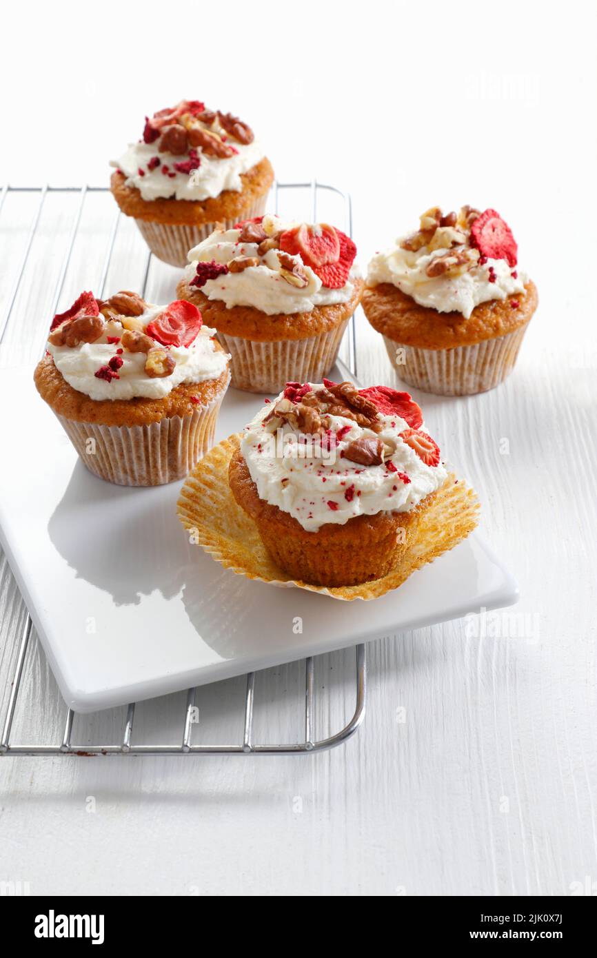 Carrot muffins decorated with cream and nuts Stock Photo - Alamy