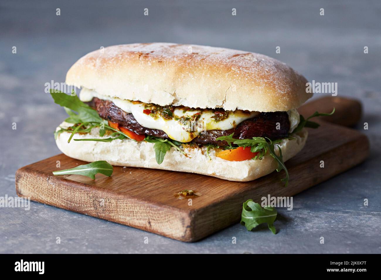 Steak sandwich with melted cheese and rocket leaves Stock Photo - Alamy