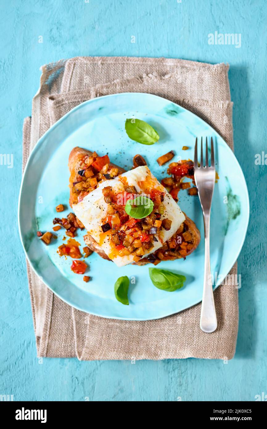 Fried cod with an aubergine and tomato salsa Stock Photo - Alamy